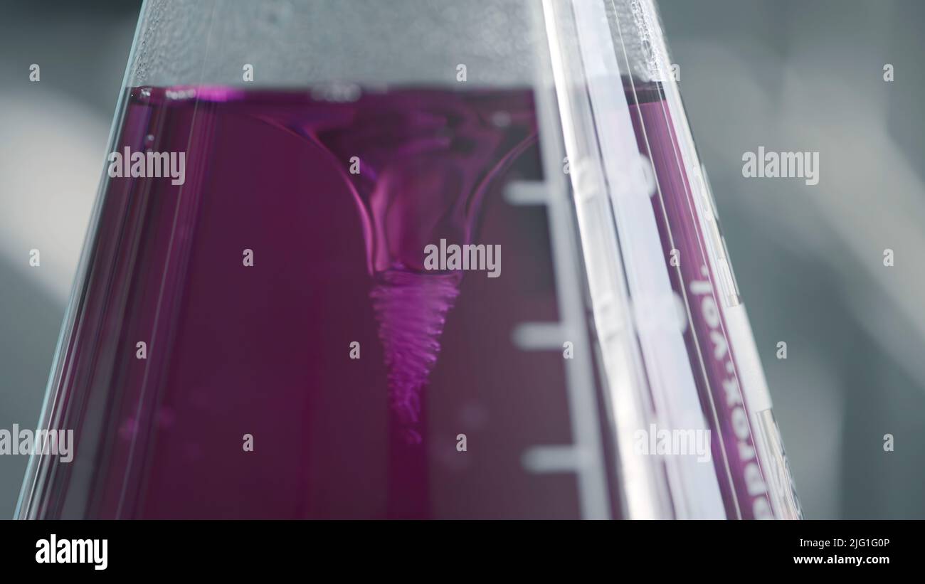 View inside of a laboratory, making tests with a pink liquid inside ...