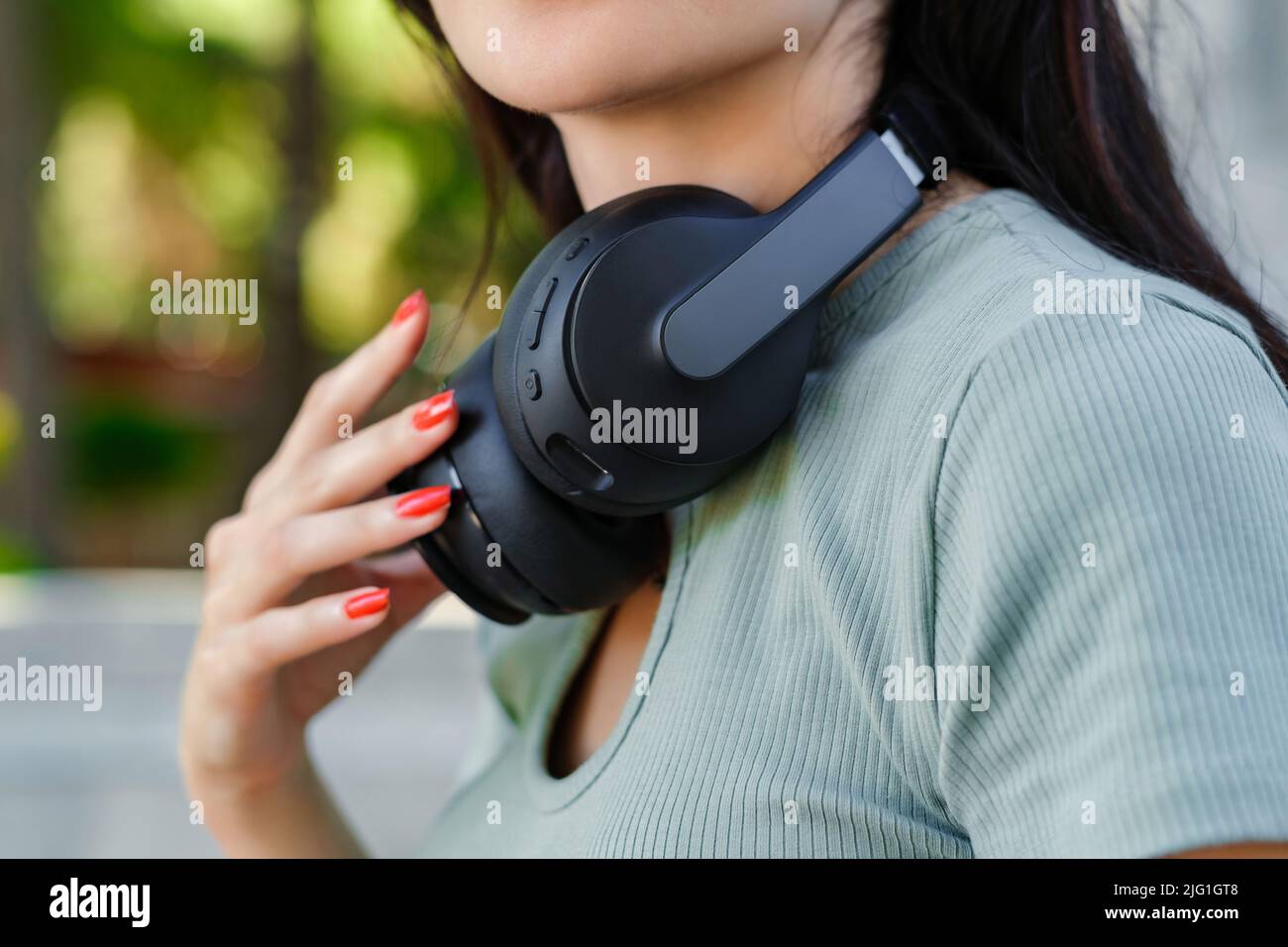 Young beautiful woman wearing turquoise tee on city park, outdoors ...