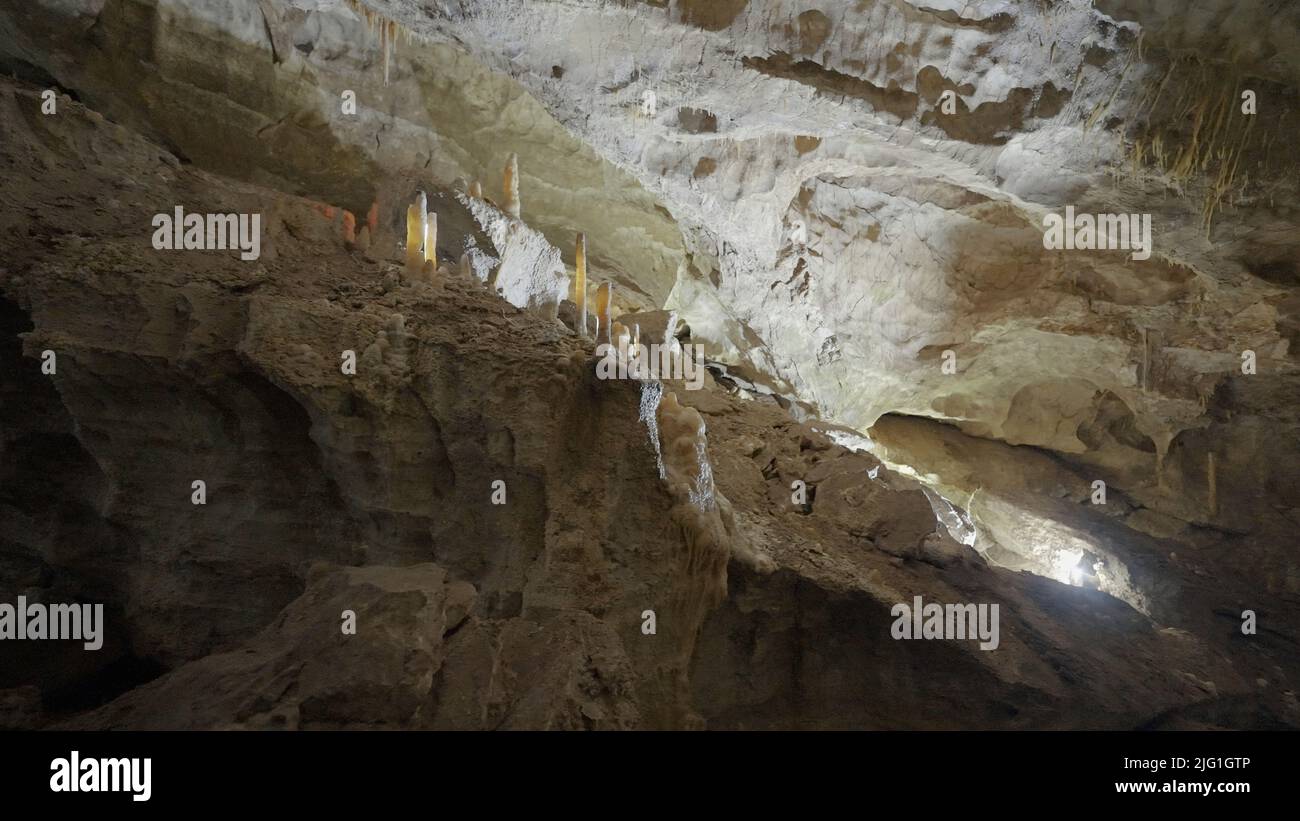 Underground cave formations of stalactites and stalagmites. Action ...