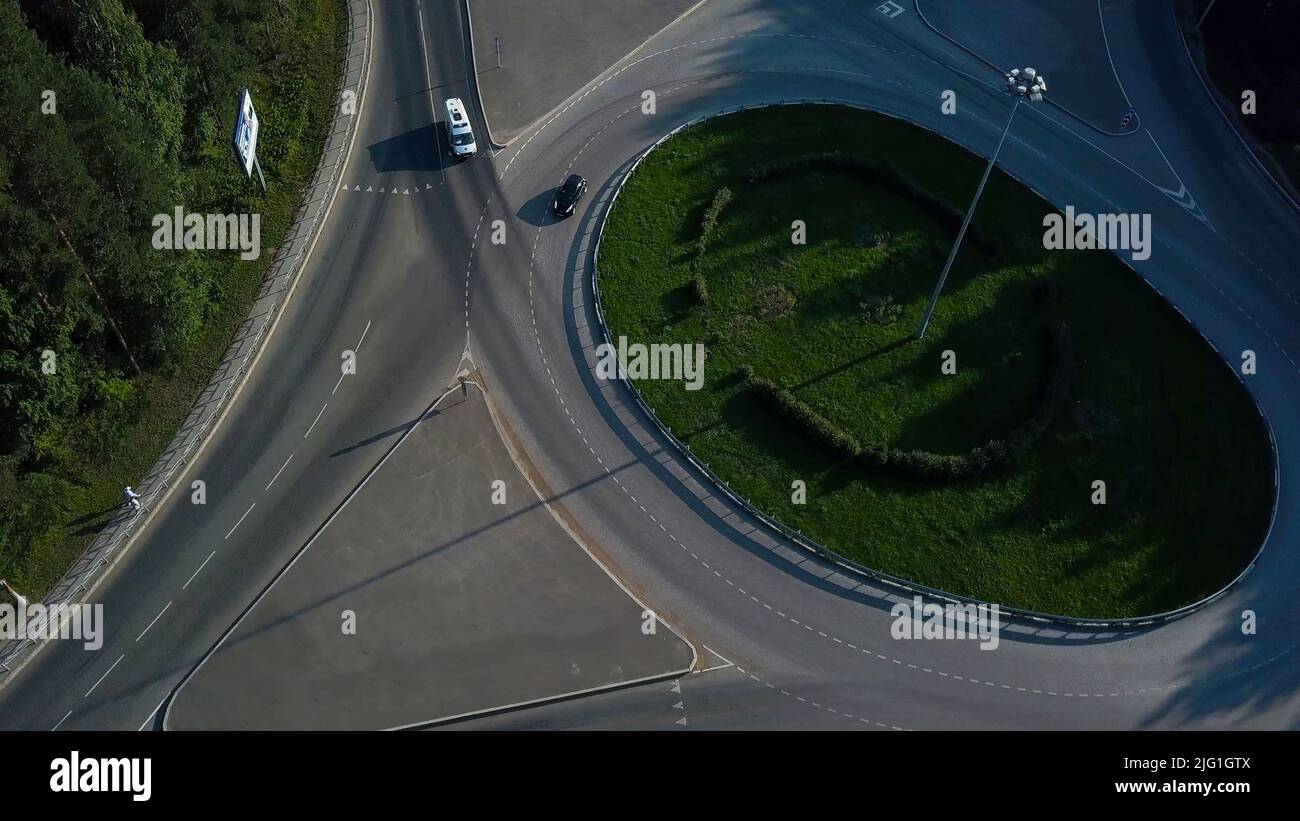 Aerial view from a drone on cars driving on the city road decorated ...