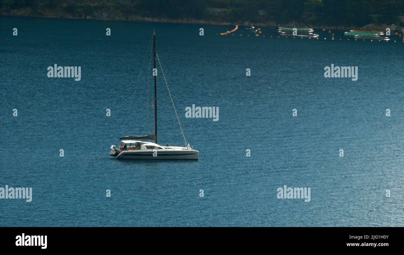 Summer landscape with a small boat sailing along green shore. Creative ...