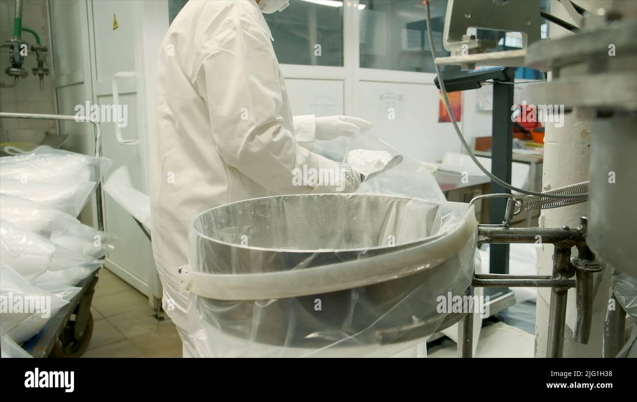 Putting flour inside the special container at the baking factory. Clip ...