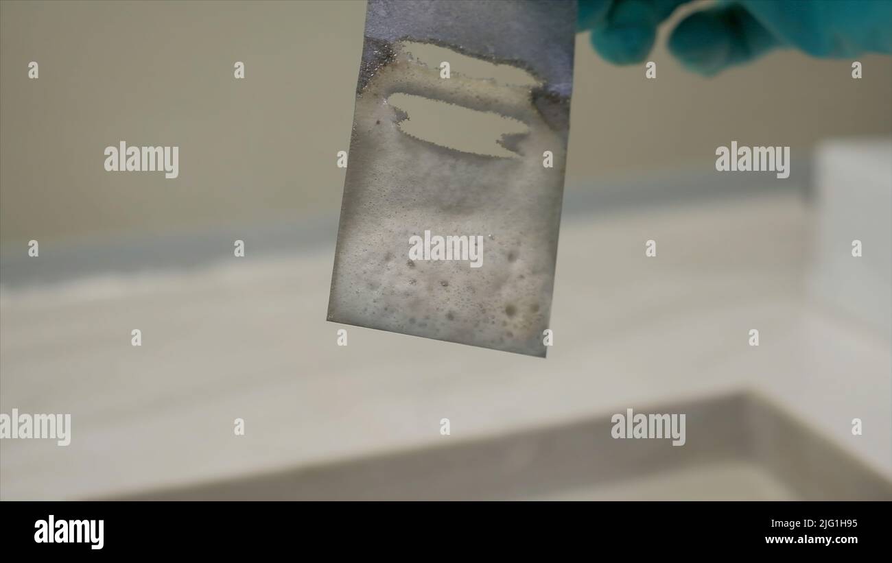 Close up of cleaning thing small metal sheet from scale. Clip. Chemical ...