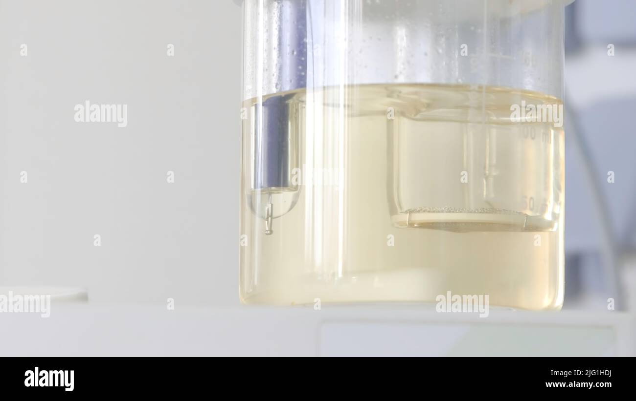 Close up of bubbling liquid substance inside flask at the laboratory ...