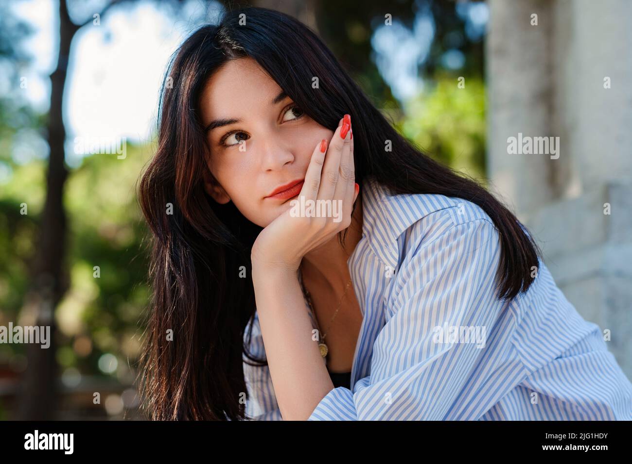 Cute caucasian woman wearing striped shirt standing on city park ...