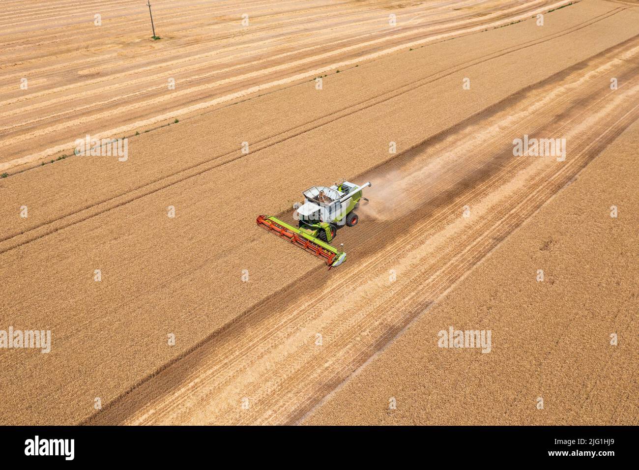 Aerial view about combine harvester working on wheat field ...