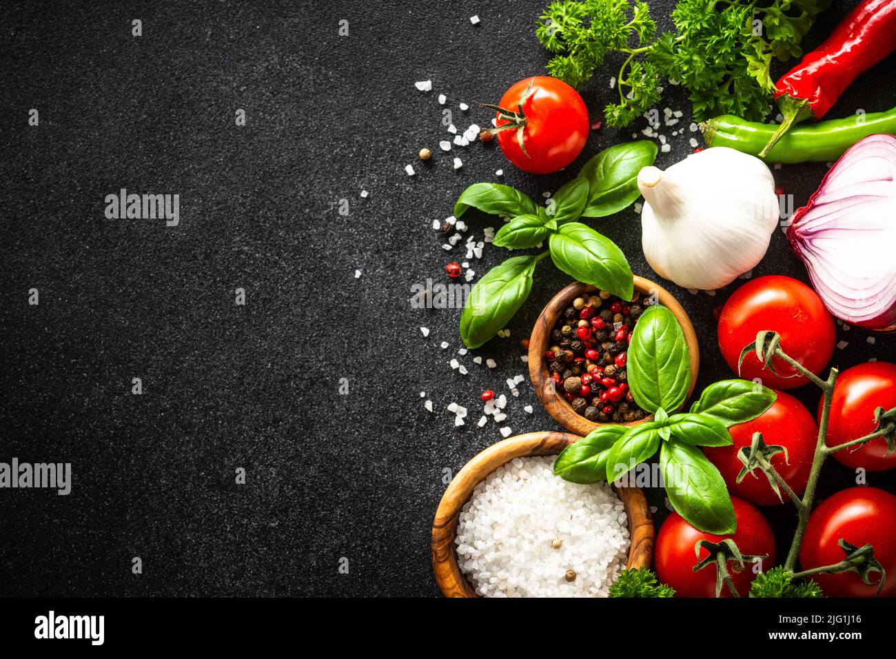 Food cooking background on black stone table Stock Photo - Alamy