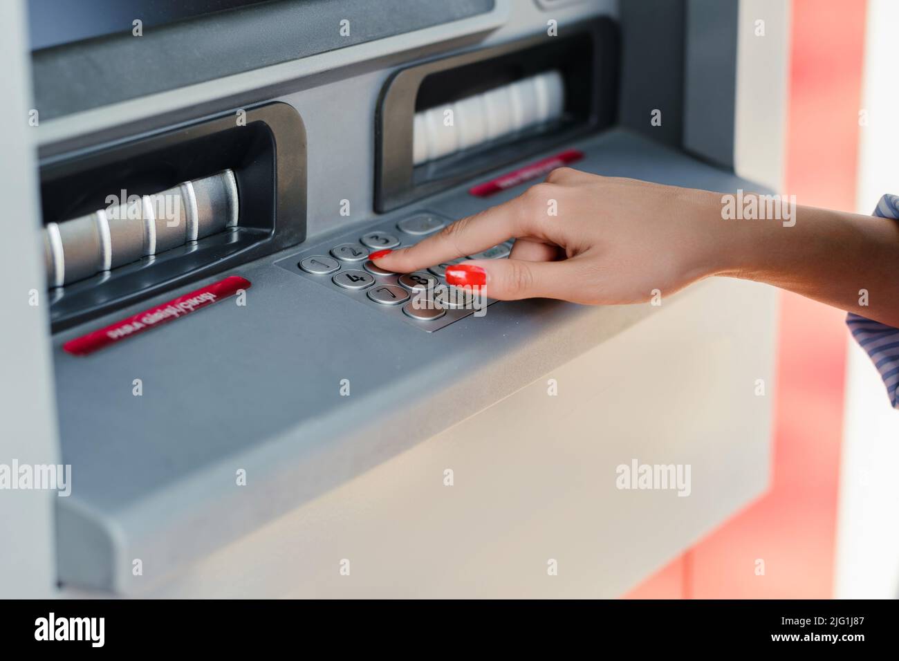 Young brunette woman wearing blue striped shirt on city park, outdoors ...
