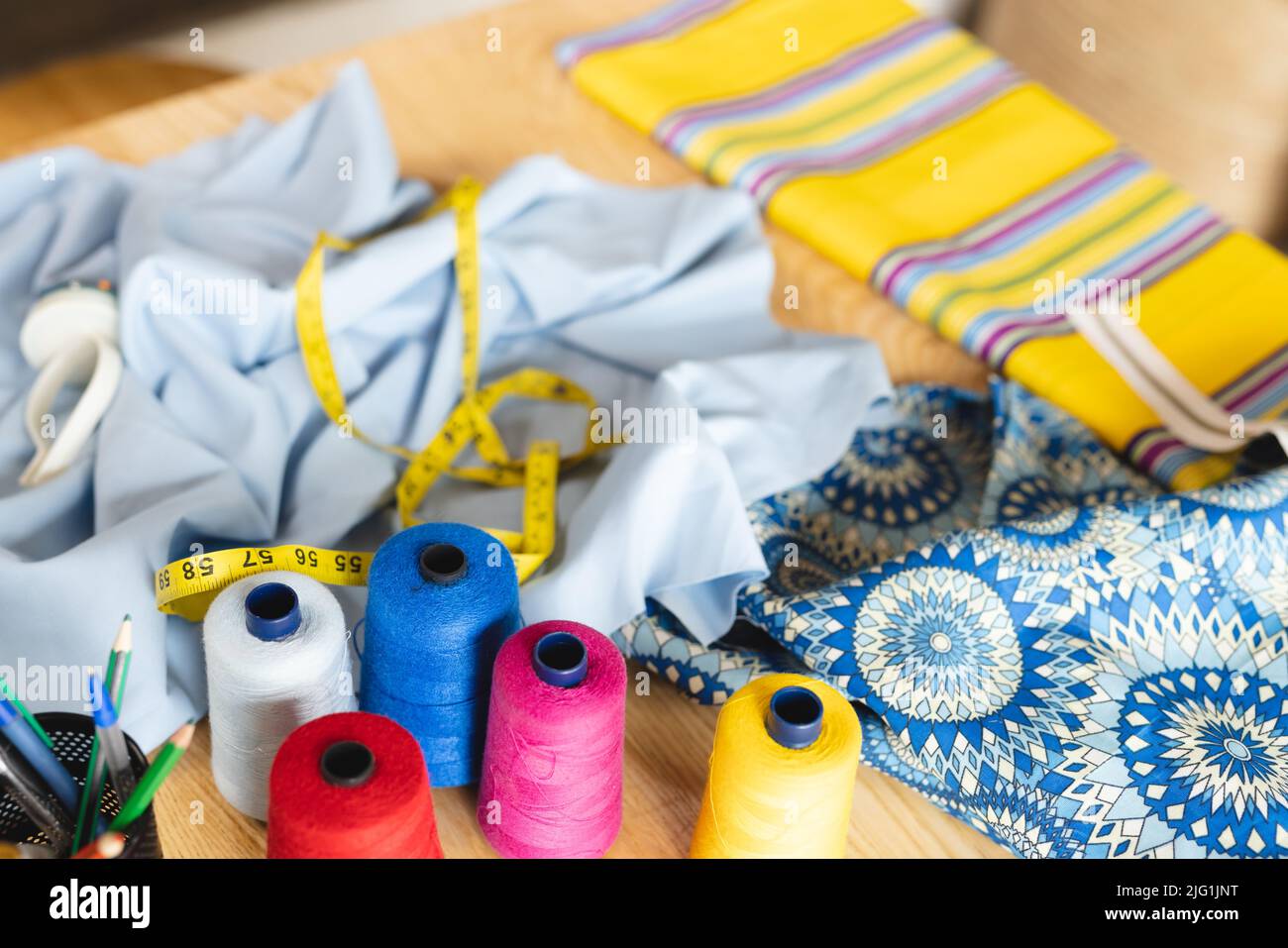 Image of colorful threads and materials in sewing workshop Stock Photo ...