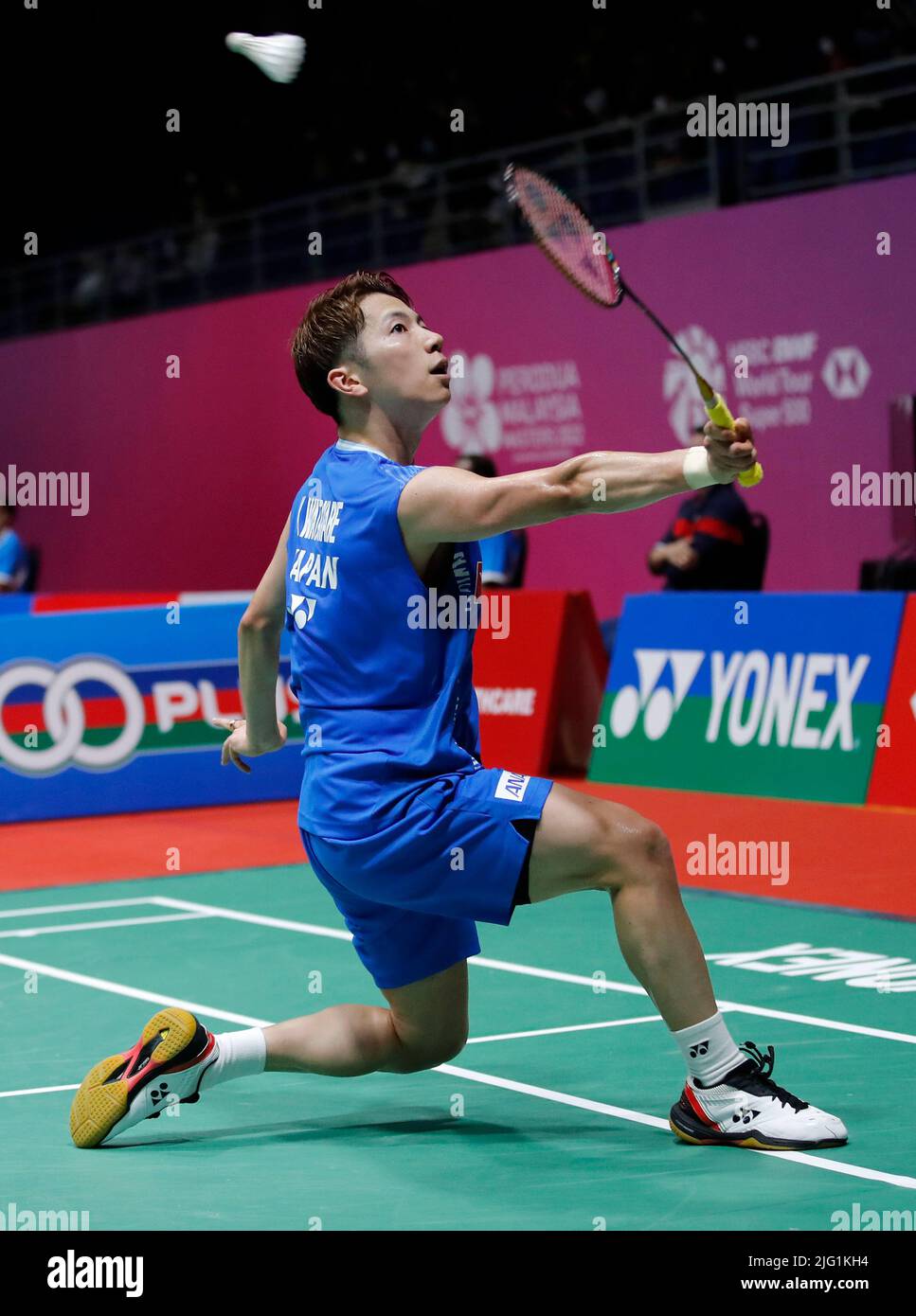 Koki Watanabe of Japan competes against Kento Momota of Japan during ...
