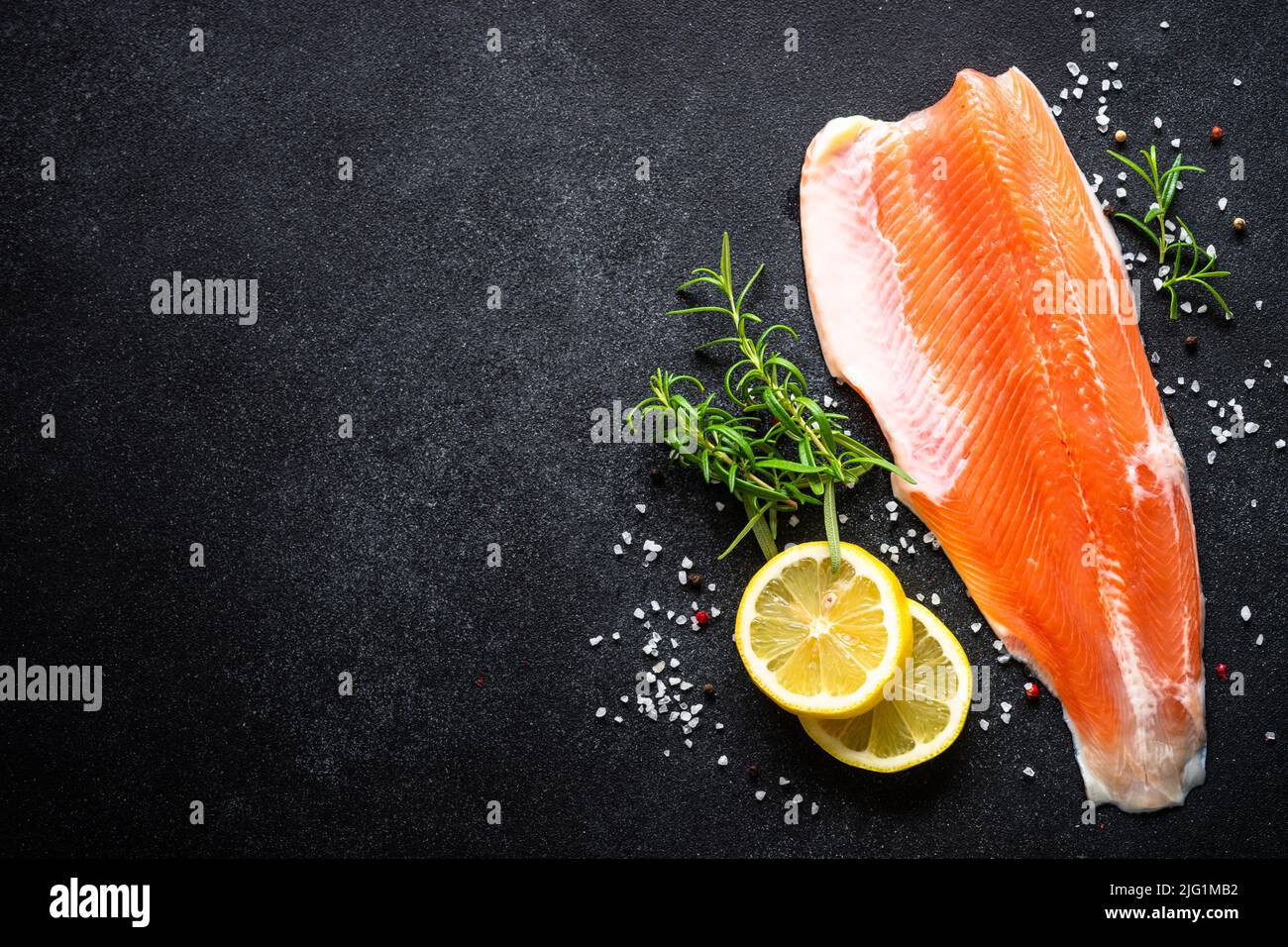 Fresh salmon fish at black top view Stock Photo - Alamy