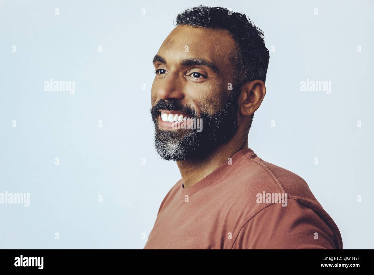 headshot portrait of a handsome bearded mid adult man smiling looking ...