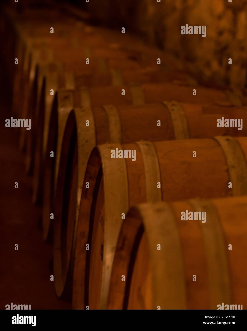 wine barrels lined up in a wine cellar. Grape fermentation Stock Photo ...