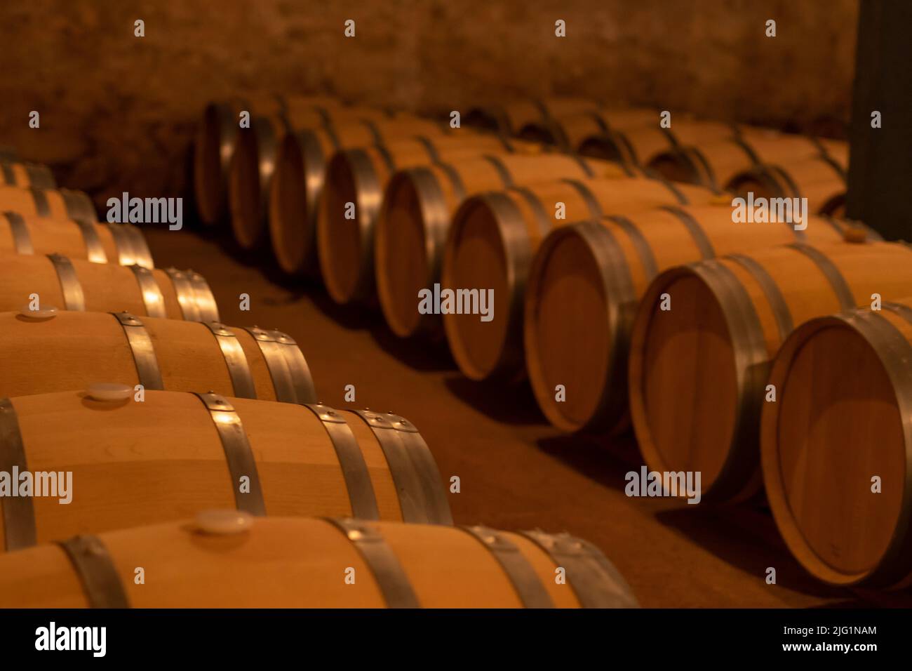 wine barrels lined up in a wine cellar. Grape fermentation Stock Photo ...