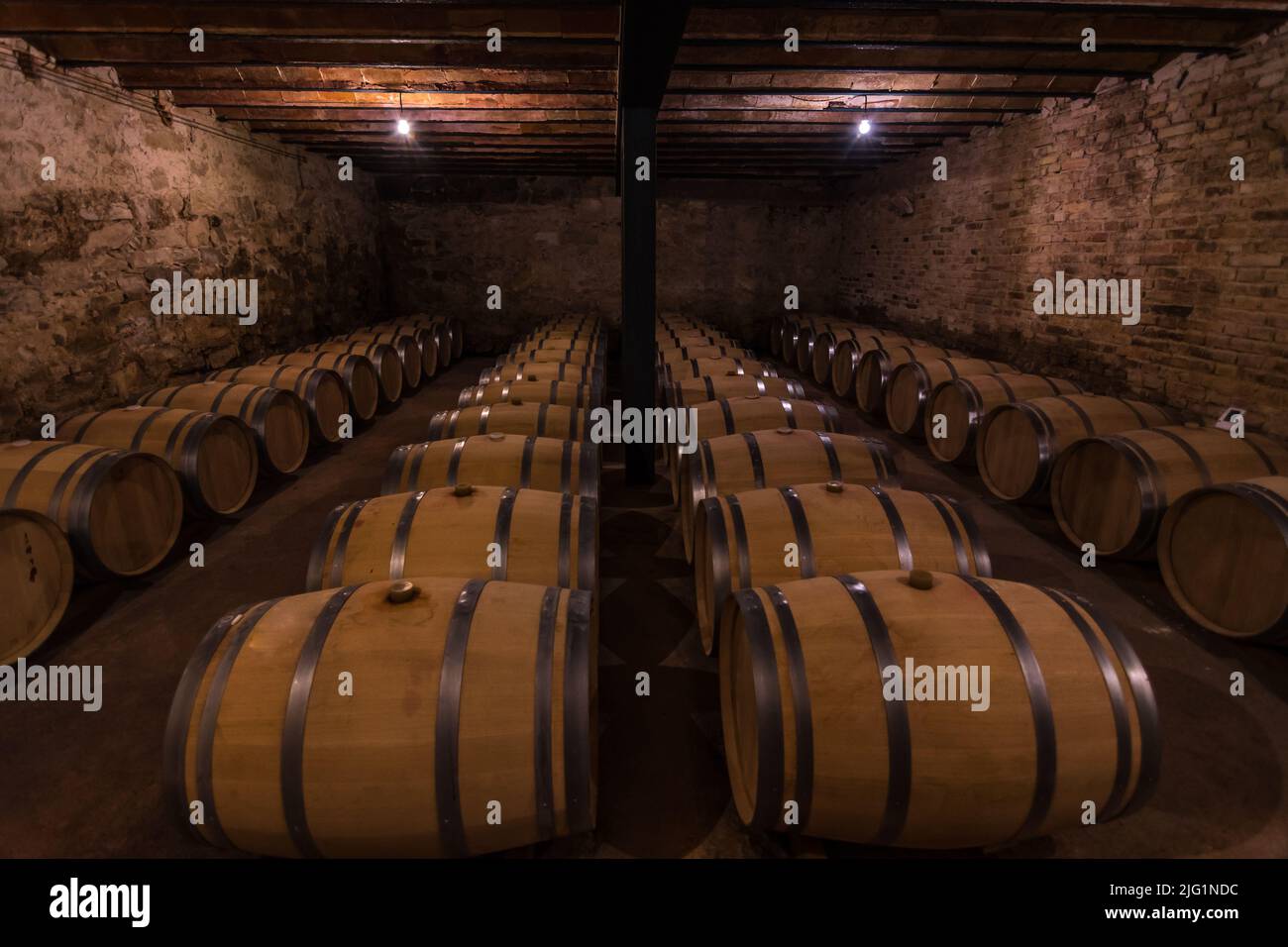 wine barrels lined up in a wine cellar. Grape fermentation Stock Photo ...