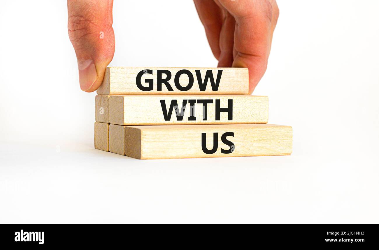 Grow with us symbol. Concept words Grow with us on wooden blocks on a ...