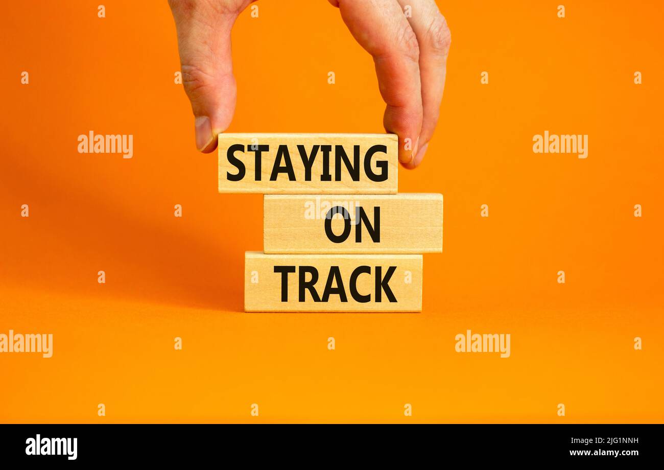 Staying on track symbol. Concept words Staying on track on wooden ...