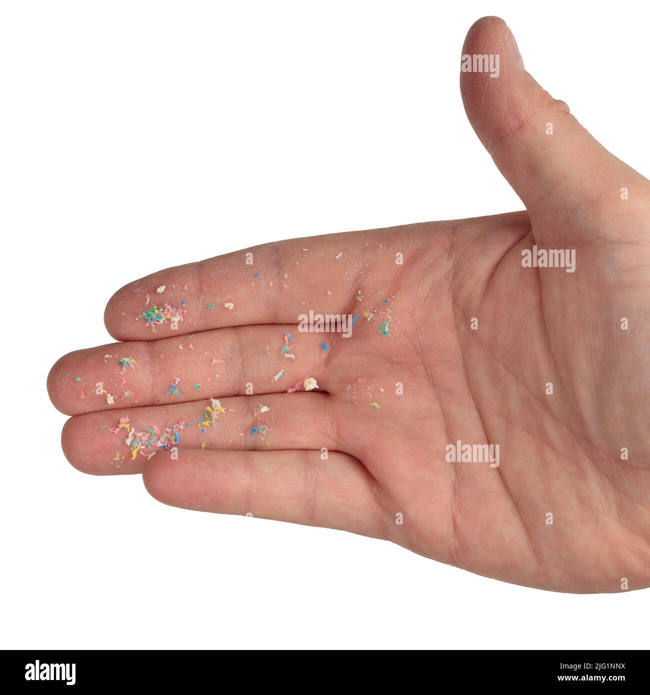 Microplastic on the hand, an exisolated background. The environmental ...