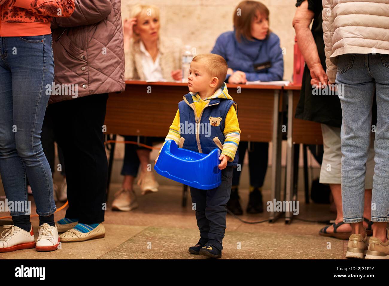 A little boy carries a potty toilet, which he received at the ...