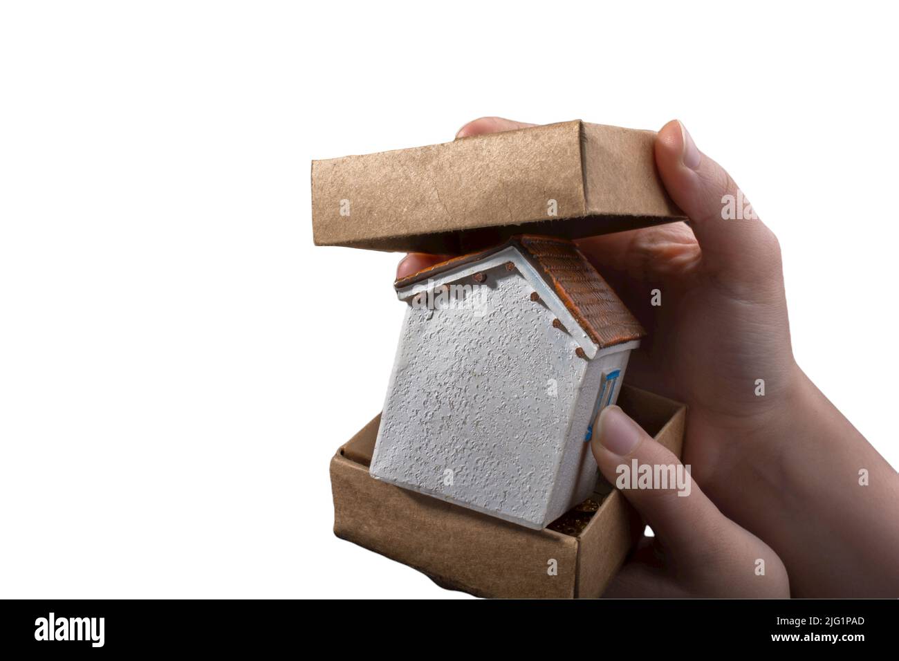 Hand holding model house on white background, family home, homeless ...