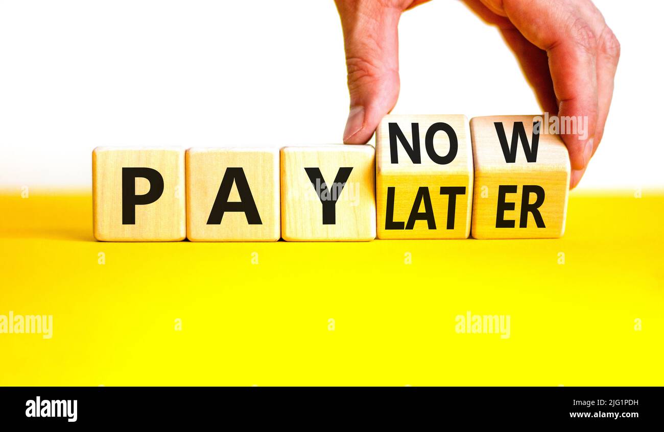 Pay later or now symbol. Businessman turns wooden cubes and changes ...
