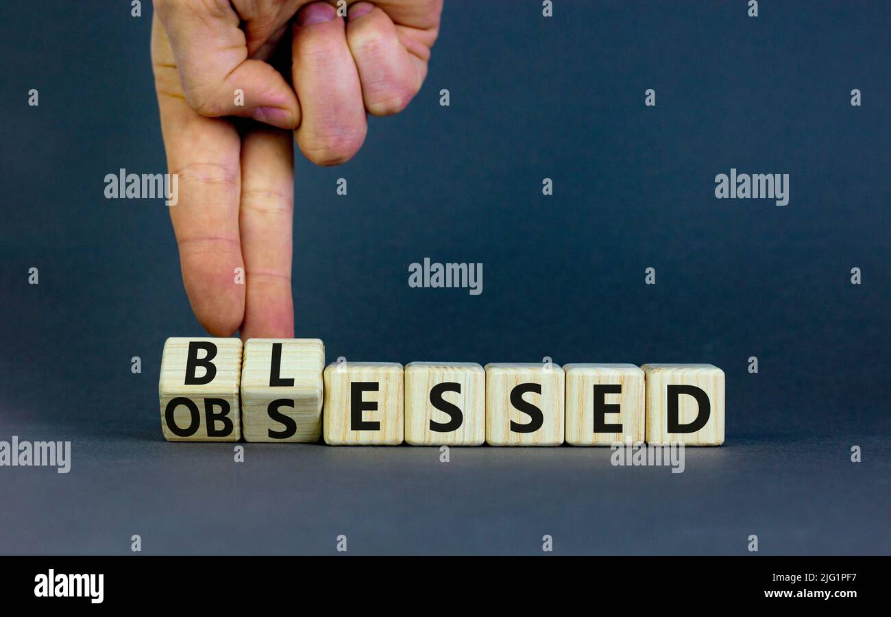 Blessed or obsessed symbol. Businessman turns wooden cubes and changes ...
