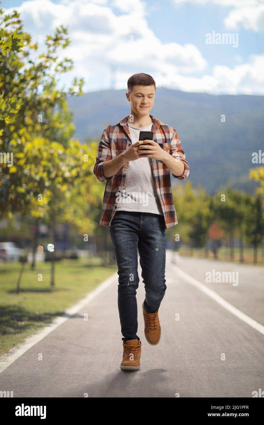 Young happy man smartphone walking hi-res stock photography and images ...