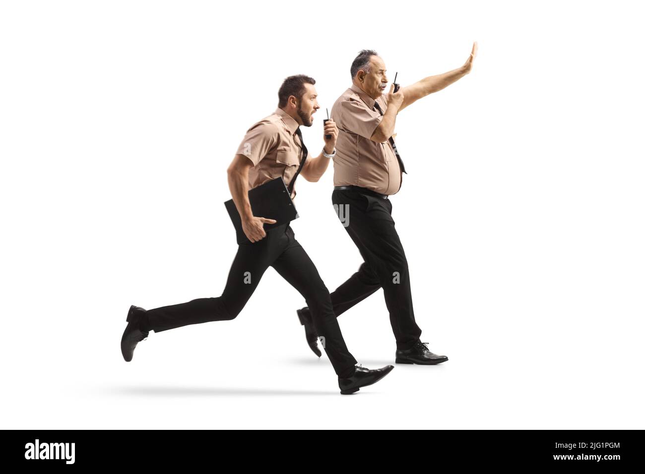 Full length profile shot of two security guards running and using ...