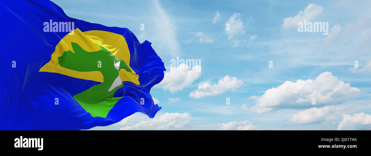 official flag of Chatham Islands New Zealand at cloudy sky background ...