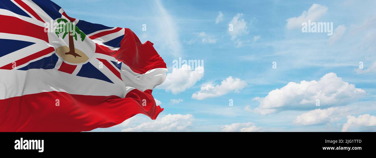 official flag of Cook Islands Federation New Zealand at cloudy sky ...