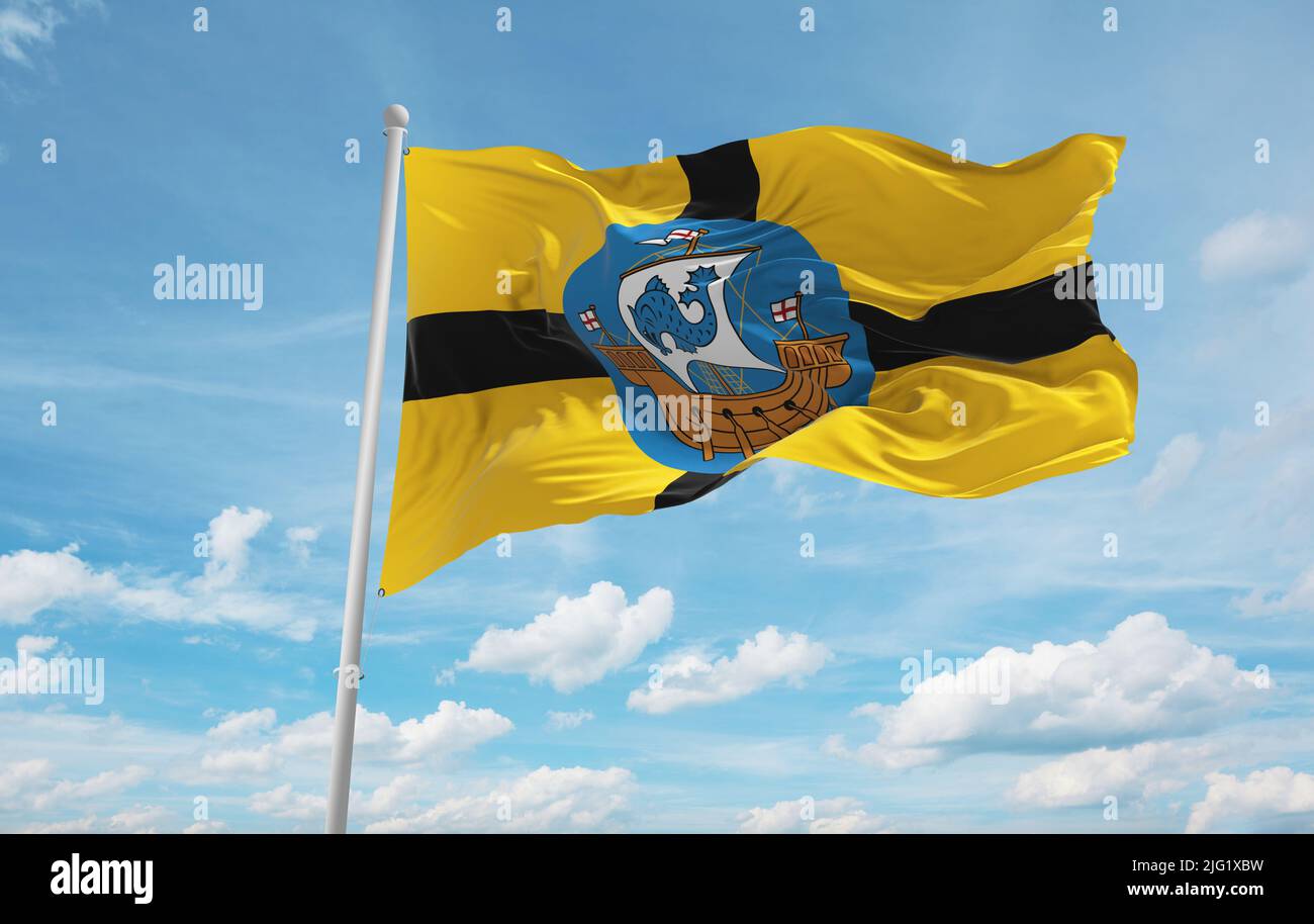 official flag of Wellington City New Zealand at cloudy sky background ...