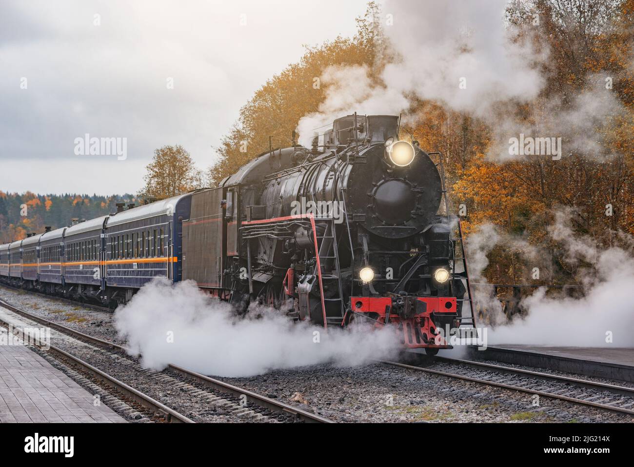 Retro steam train departs from the station wooden platform Stock Photo ...