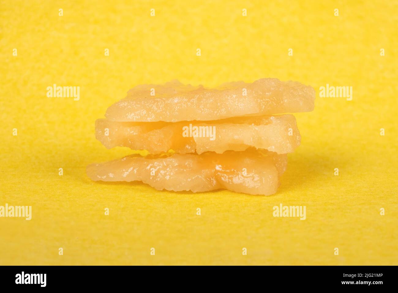 high thc dab, pieces of yellow cannabis wax and green leaf, marijuana ...