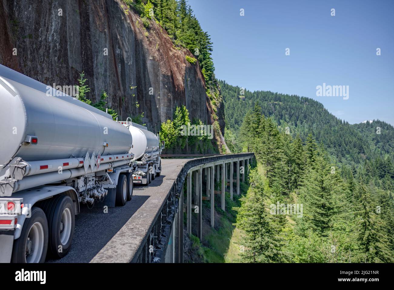 Bonnet white American big rig semi truck transporting liquid cargo in ...