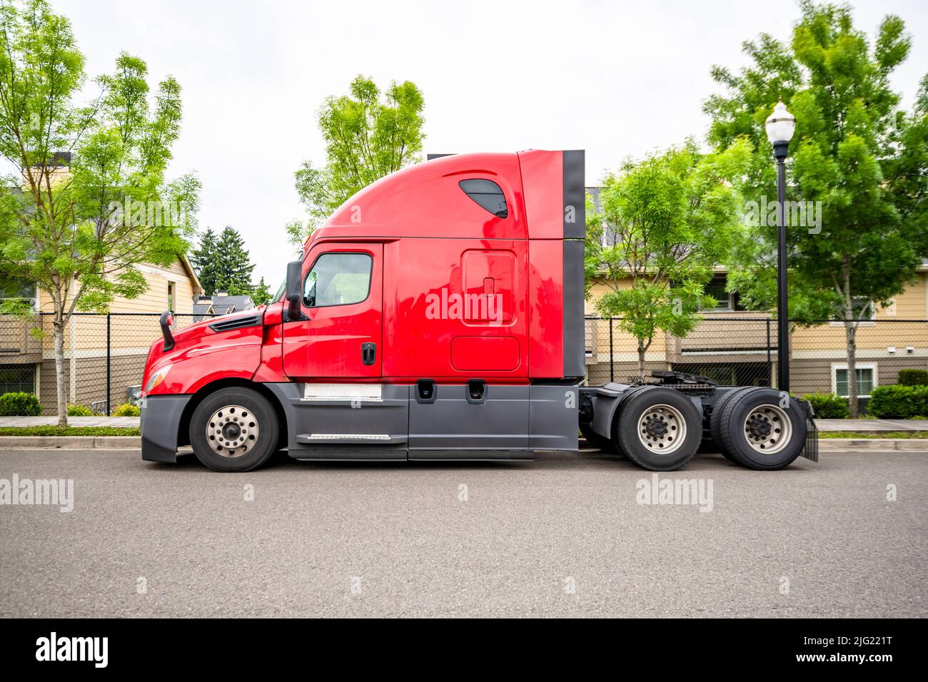 Red industrial big rig semi truck with truck driver cab sleep ...