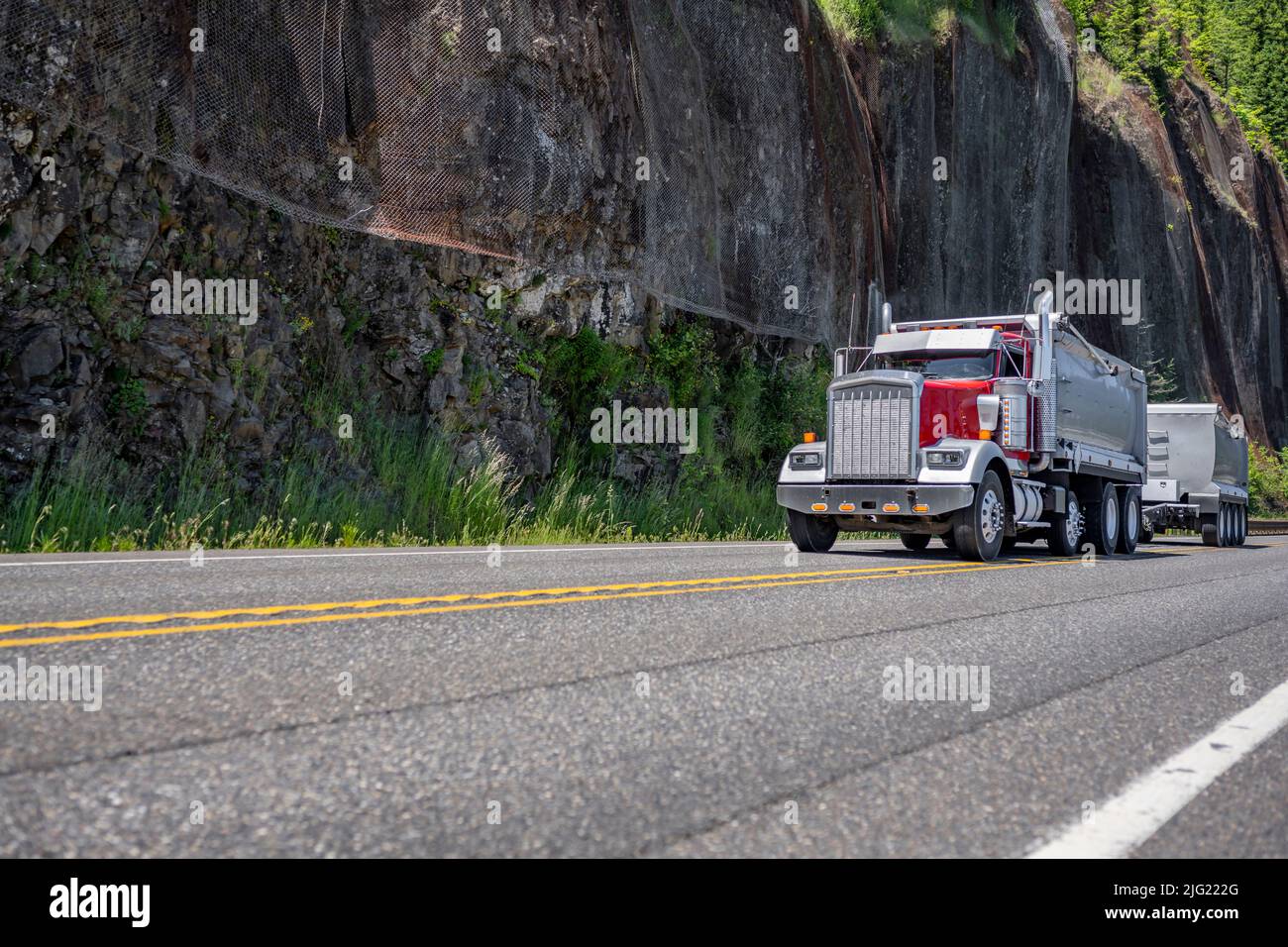 Classic red American big rig tipper semi truck tractor transporting ...