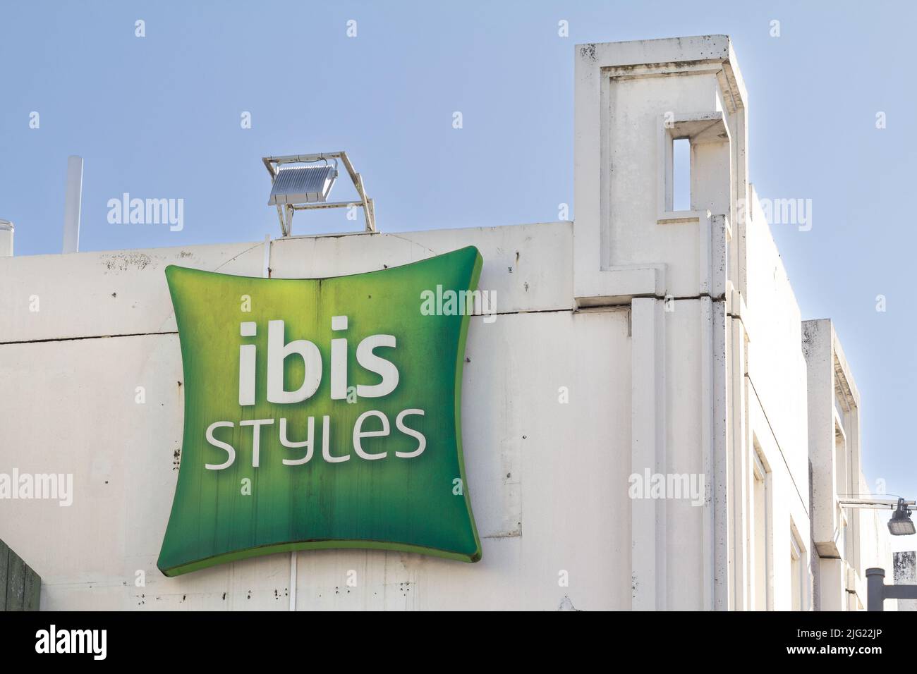Picture of a sign with the logo of Ibis Styles in the city center of ...