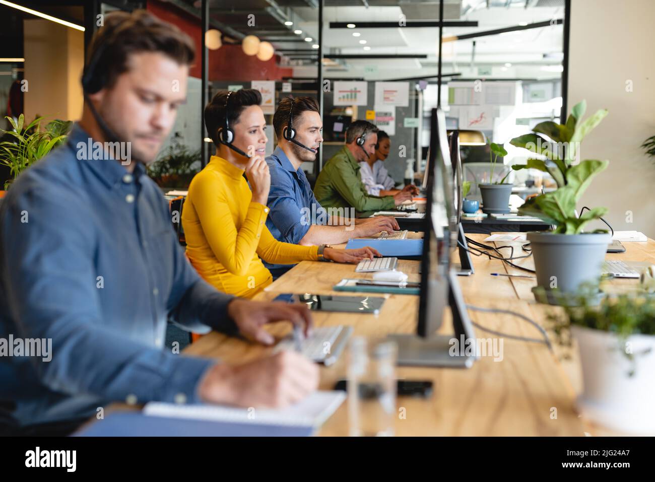 Multiracial male and female customer service executives working in ...