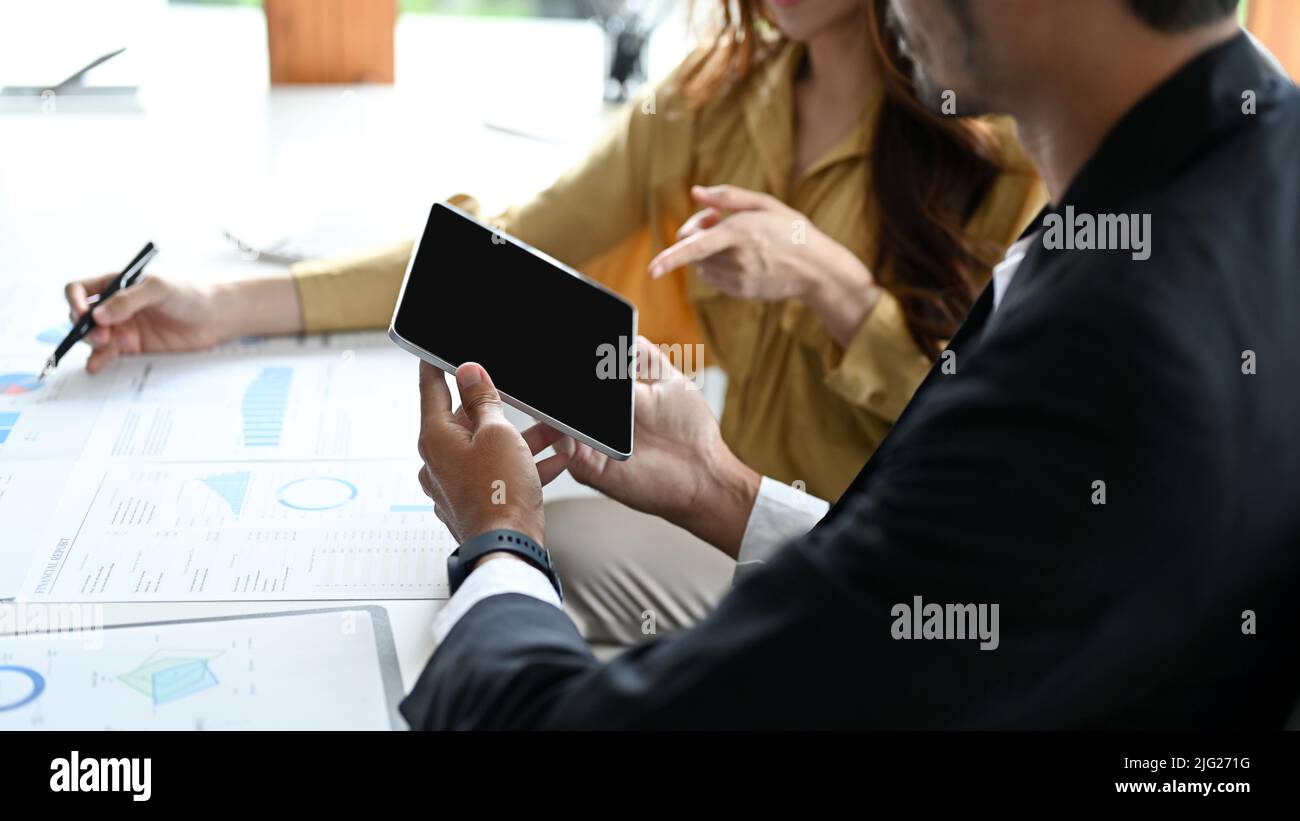 Professional intelligent Asian male financial strategist using tablet ...