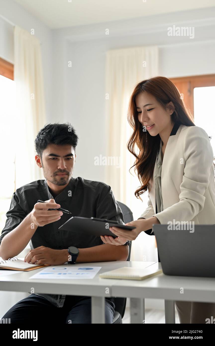 Professional asian male boss training and coaching his beautiful female ...