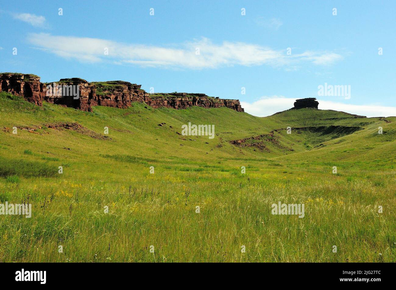 A deep hollow between high hills and stone formations on the peaks ...