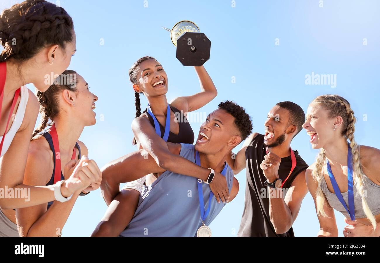 Group of a young fit diverse team of athletes celebrating their victory ...