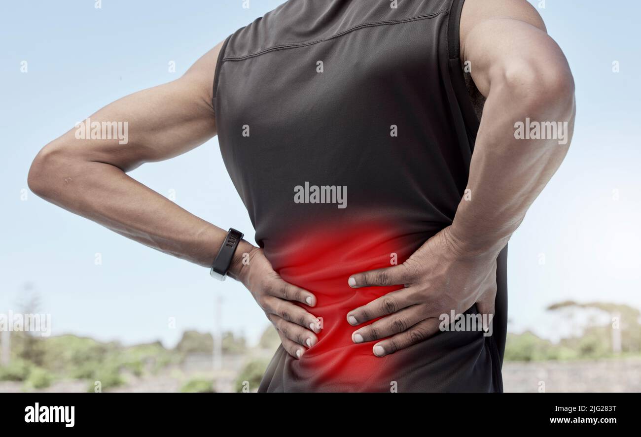 Closeup shot of a young male athlete suffering with back pain while ...