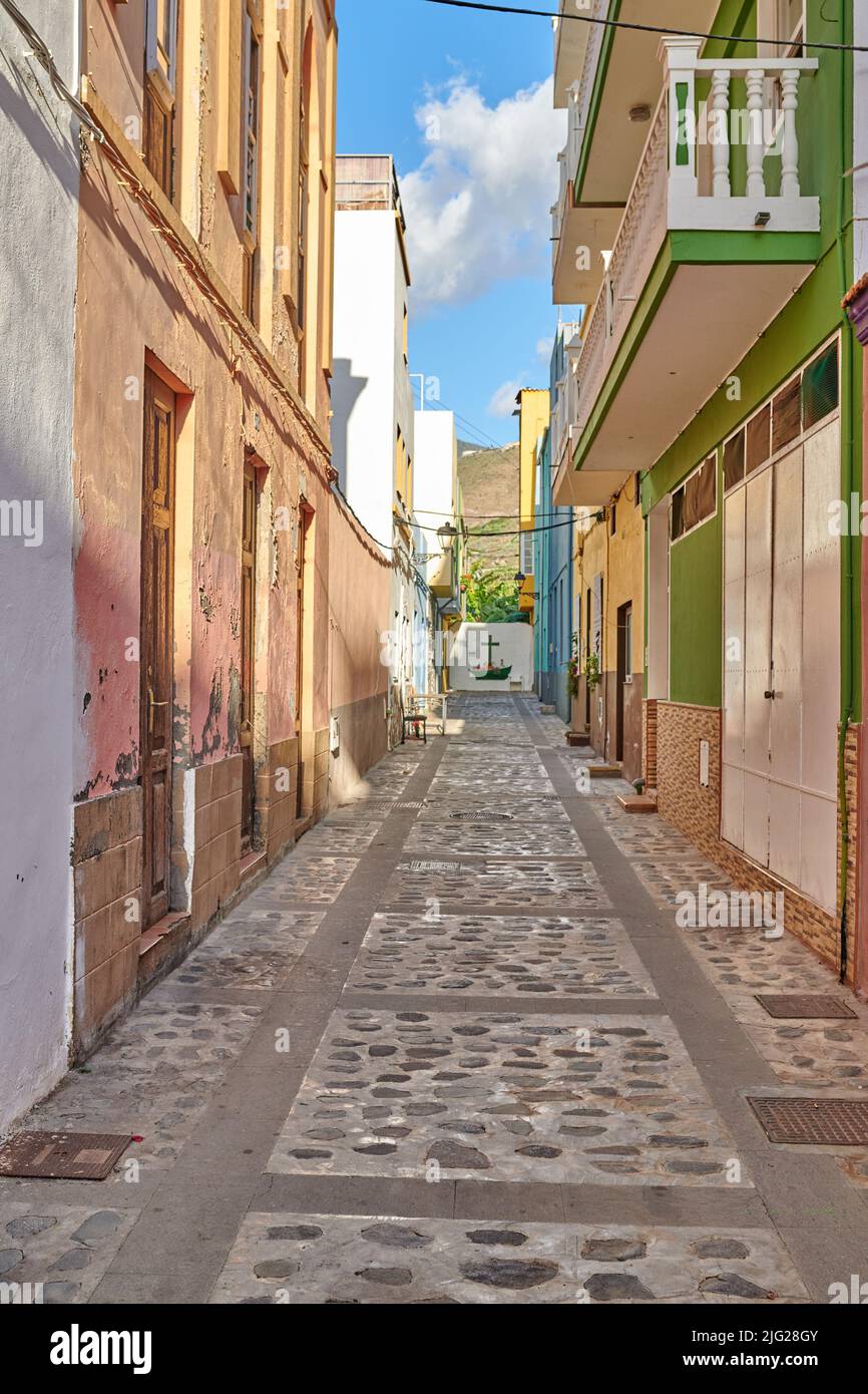 Empty cobbled street in a rural European tourist town. A quiet narrow ...