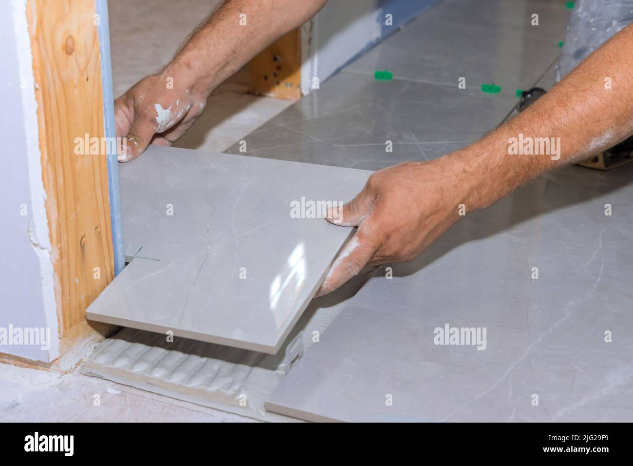 The application of tile adhesive to the floor during the process of ...