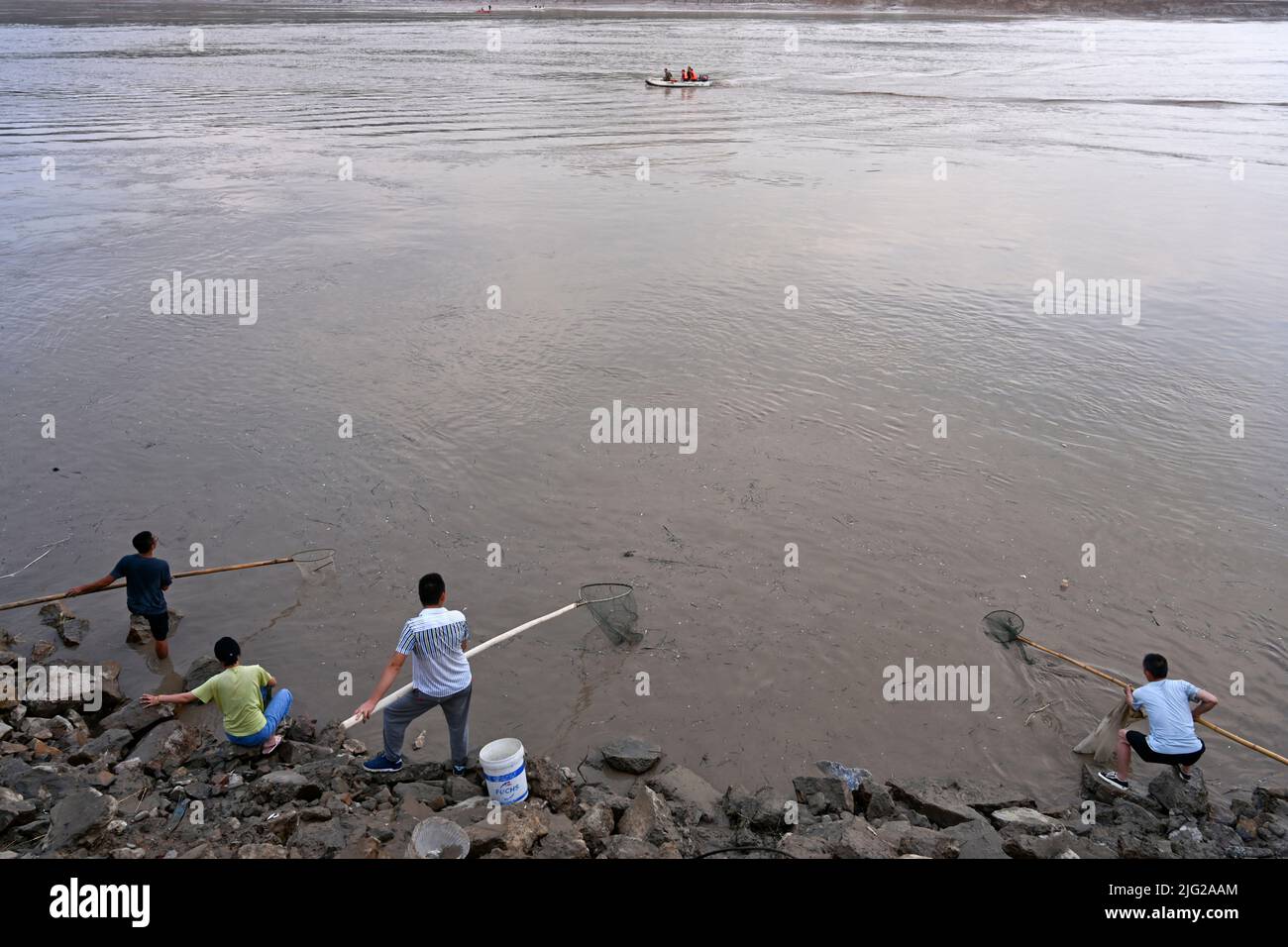 YUNCHENG, CHINA - JULY 6, 2022 - People fish from the Yellow River in ...