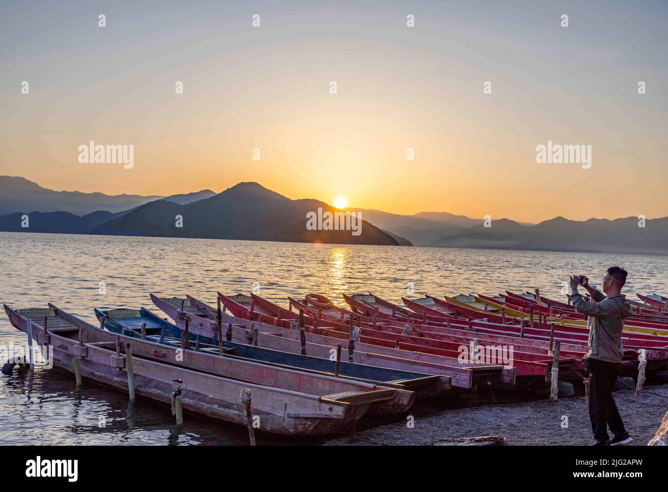 LIJIANG, CHINA - JULY 7, 2022 - Tourists visit the bank of Lugu Lake in ...