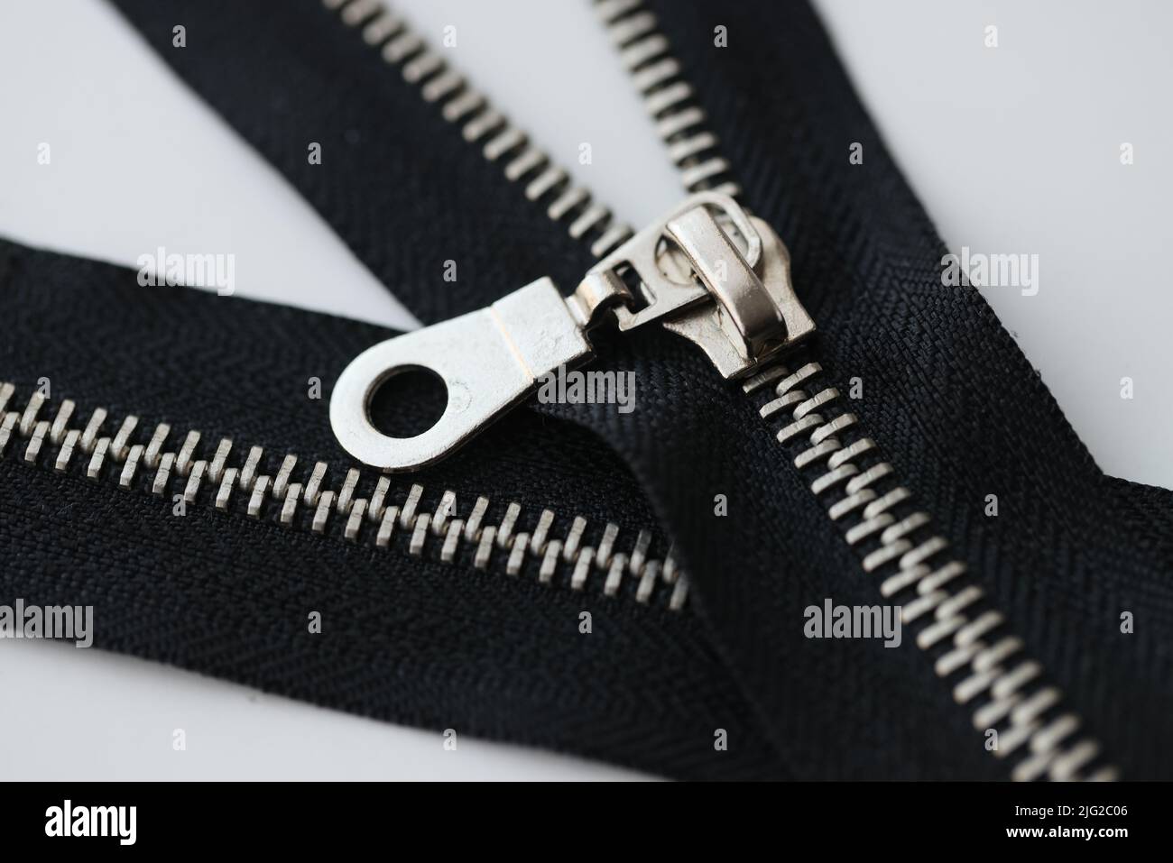 Open and closed metal zippers for clothing on white background Stock ...