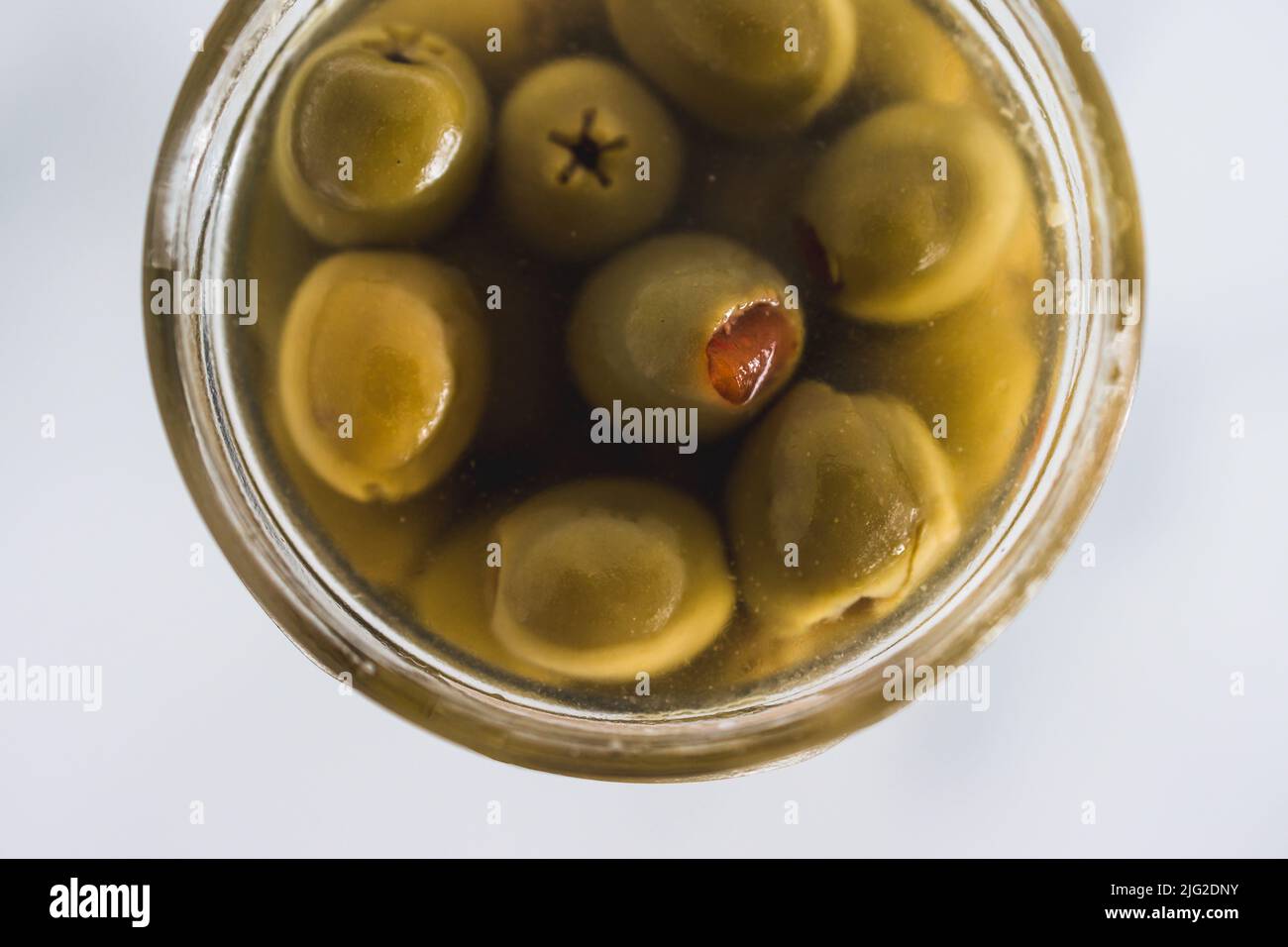 pantry jar with green stuffed olives shot from top down perspective as ...