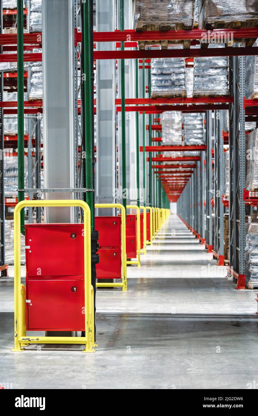 Lifting equipment with cargo near high shelving in storage Stock Photo ...